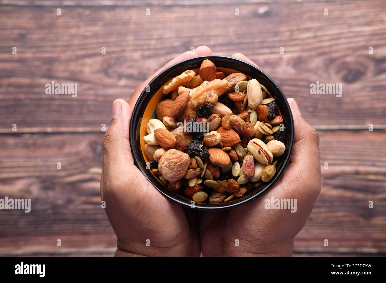 Hand holding nut bowl hi-res stock photography and images - Alamy
