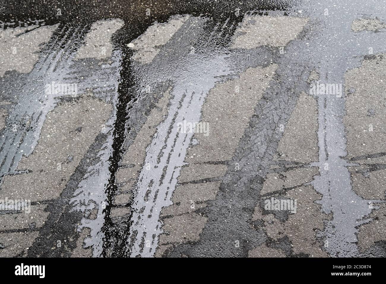Heavy rain drops falling on city street during downpour. Wet ashpalt ...