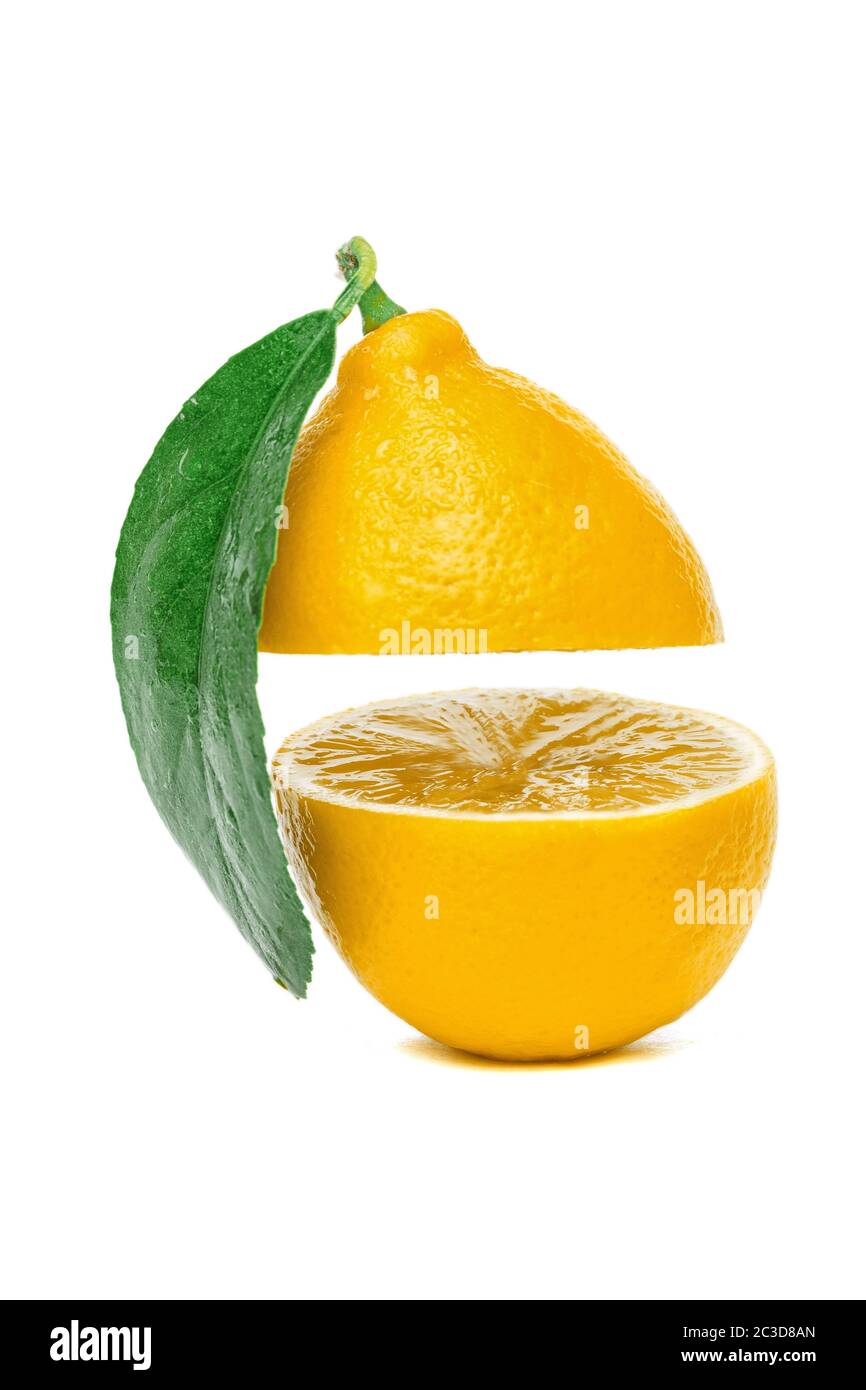 yellow lemon cut into two parts with a leaf isolated on a white ...