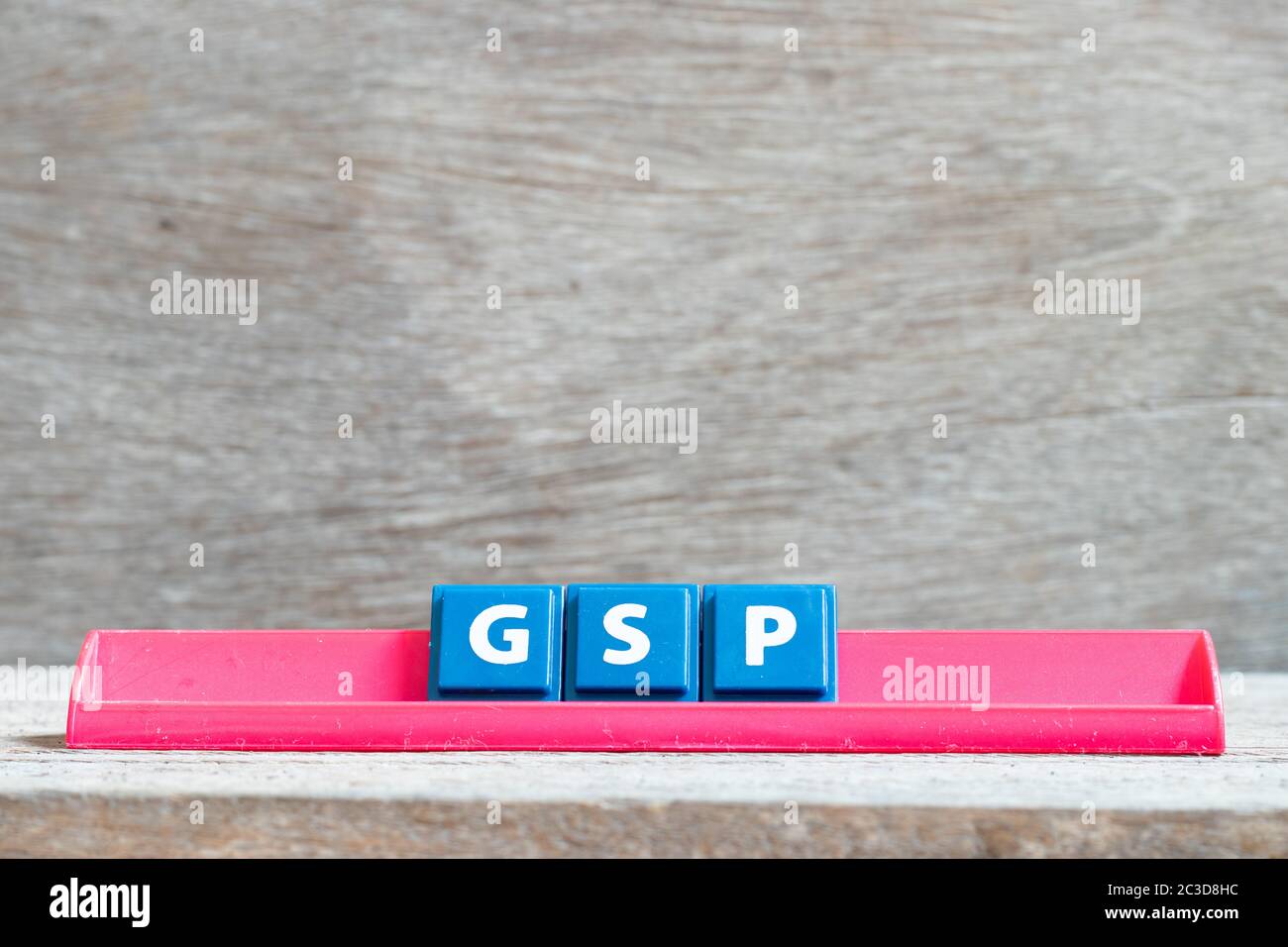Tile letter on red rack in word (abbreviation of good storage practice ...