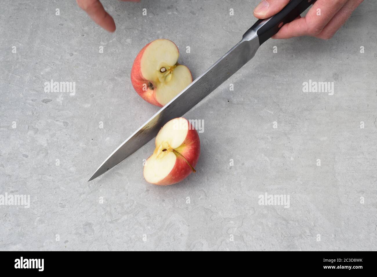 Cutting an apple fresh fruit preperation inside a kitchen on a chopping ...
