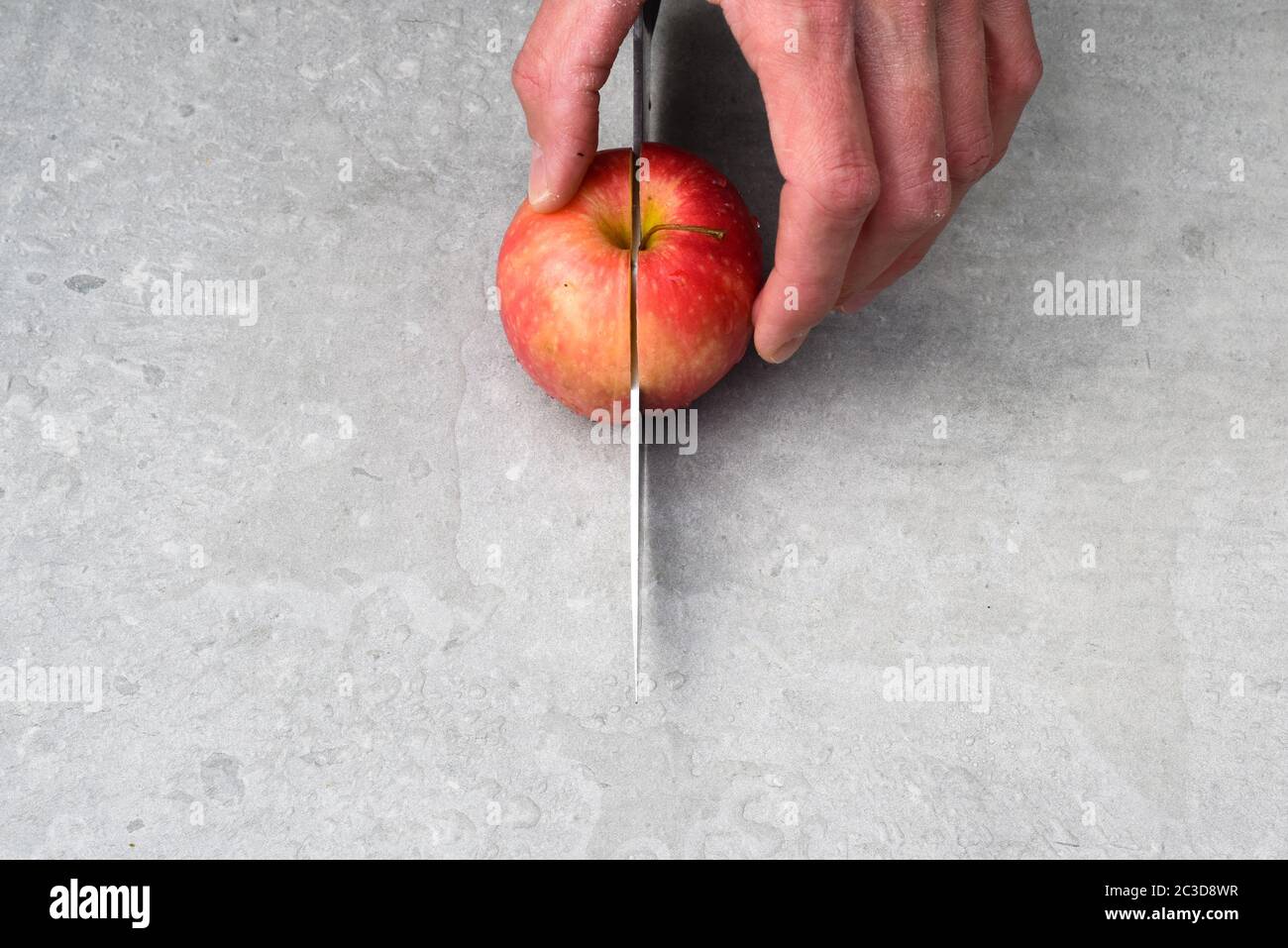 Cutting an apple fresh fruit preperation inside a kitchen on a chopping ...