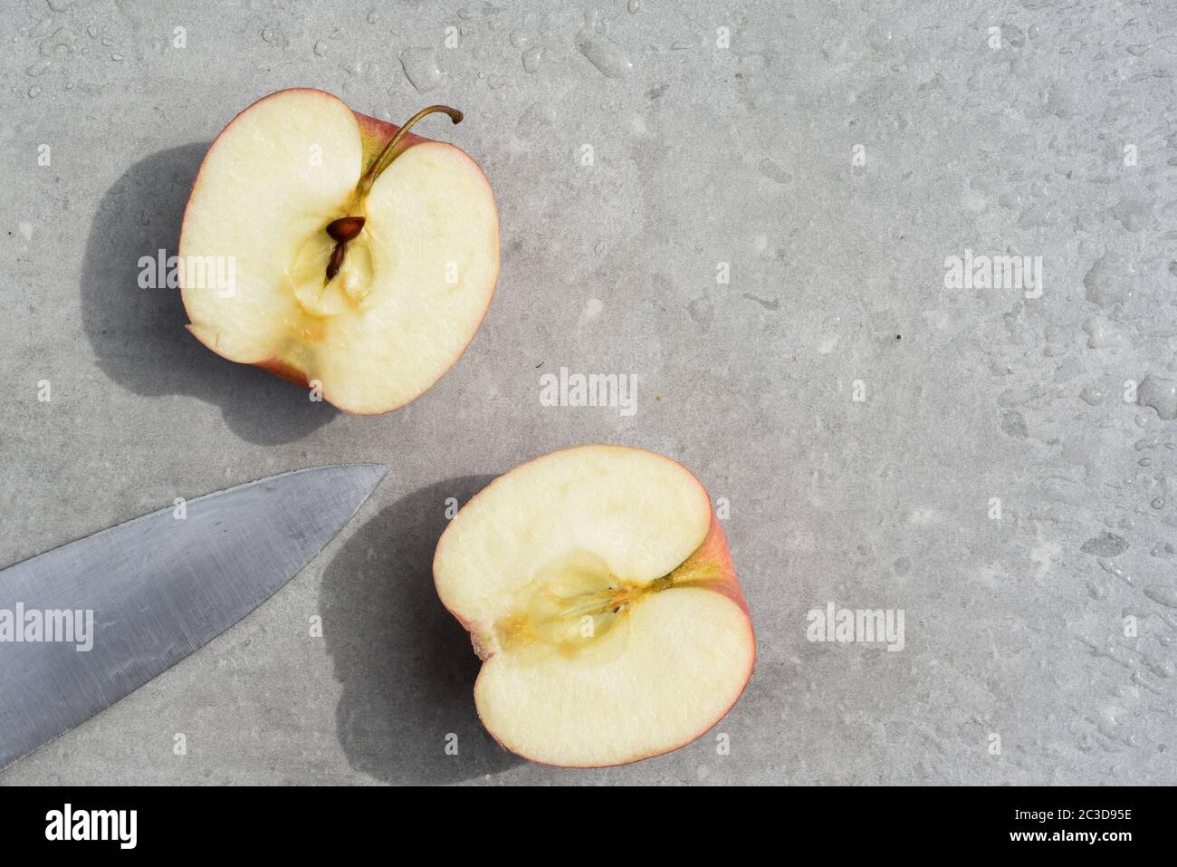 Cutting an apple fresh fruit preperation inside a kitchen on a chopping ...