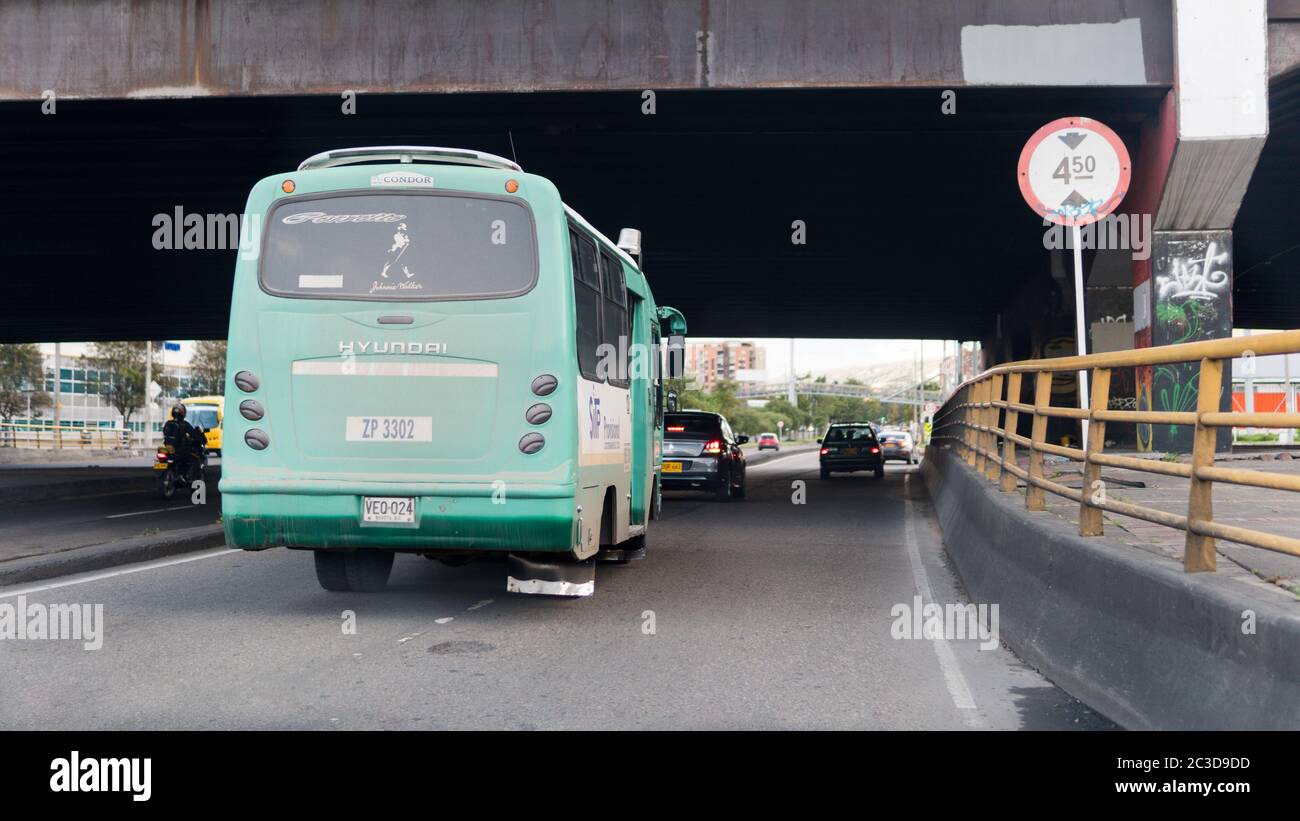 Old, polluting bus on 68th street in Bogota, Colombia. Bridge; tunnel ...