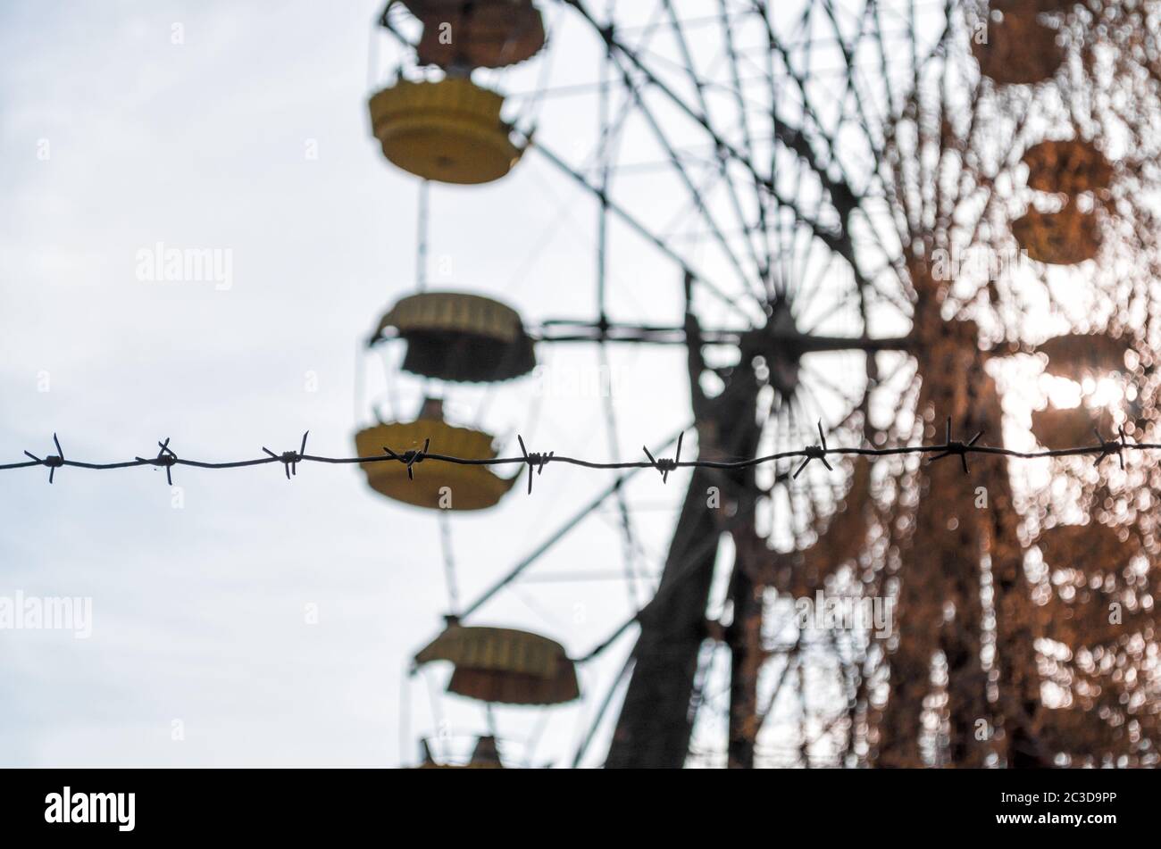 barbed wire and cabins carousel wheel in an abandoned amusement park in ...