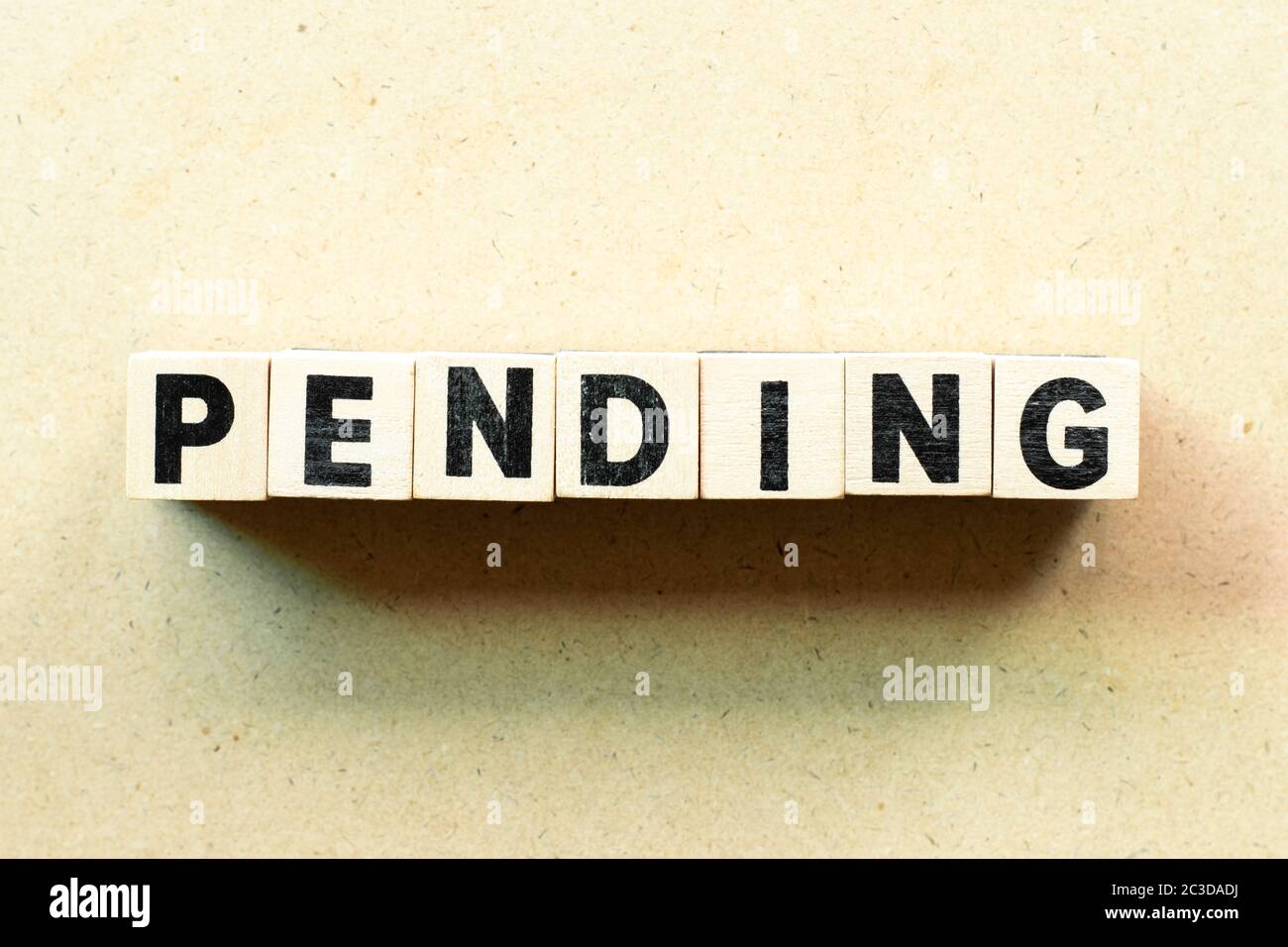 Letter block in word pending on wood background Stock Photo - Alamy