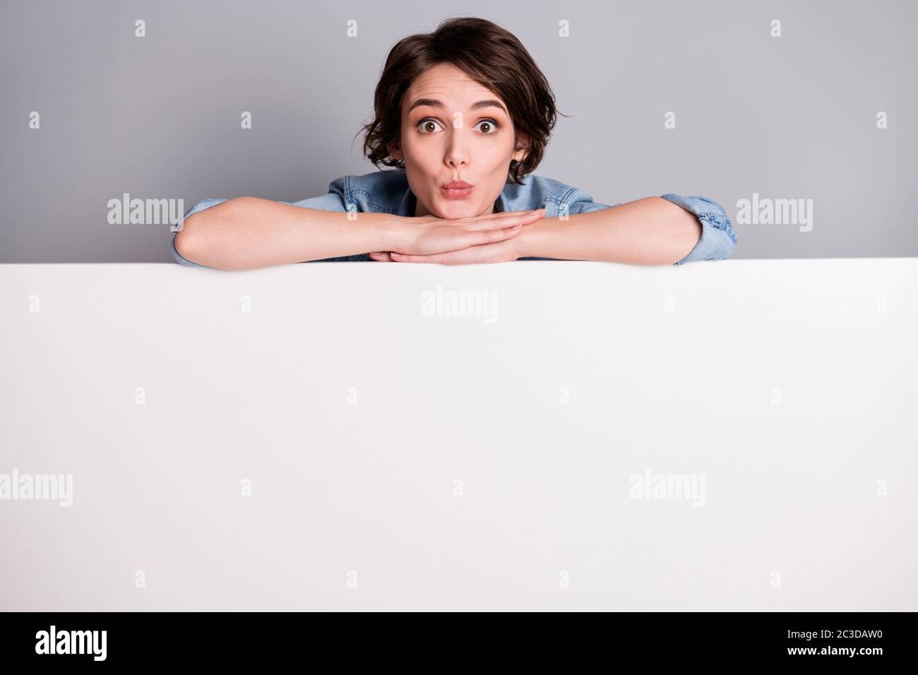 Photo of funny pretty cheerful lady lean hands big empty paper poster ...