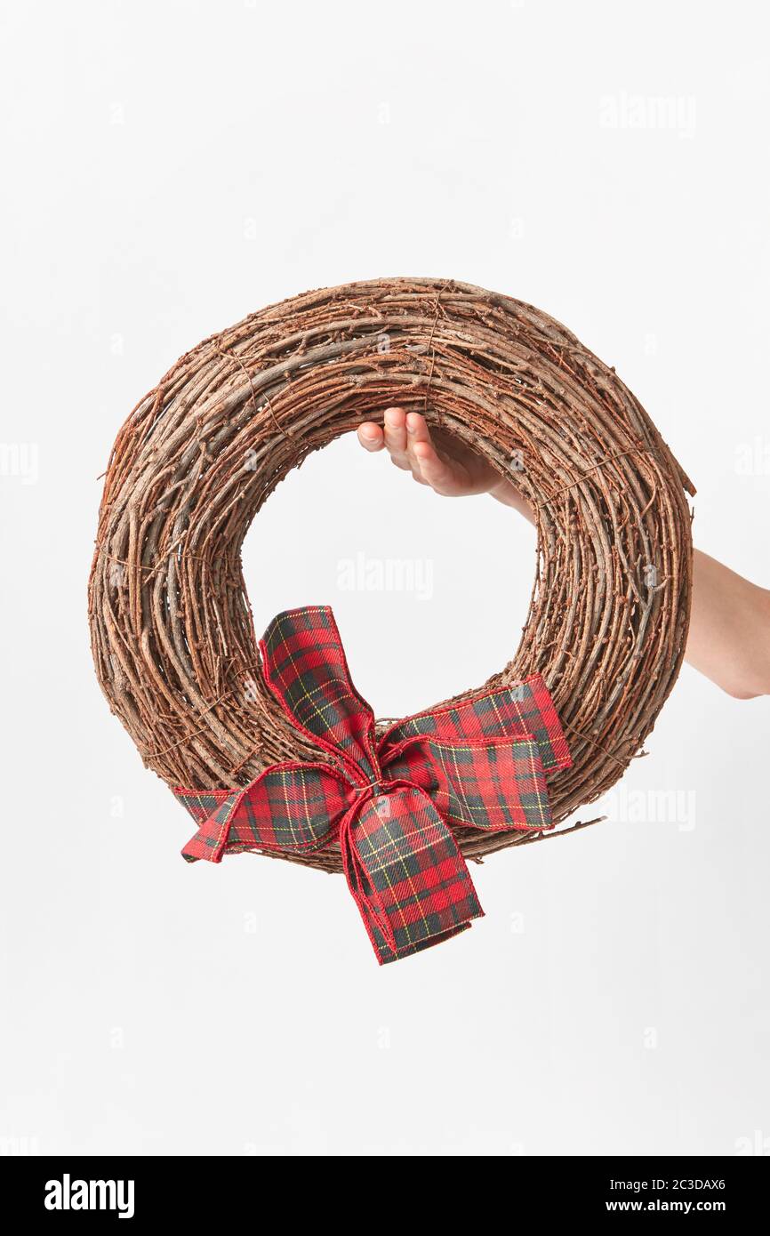 Round wreath from dry twigs with bow in a woman hand Stock Photo - Alamy