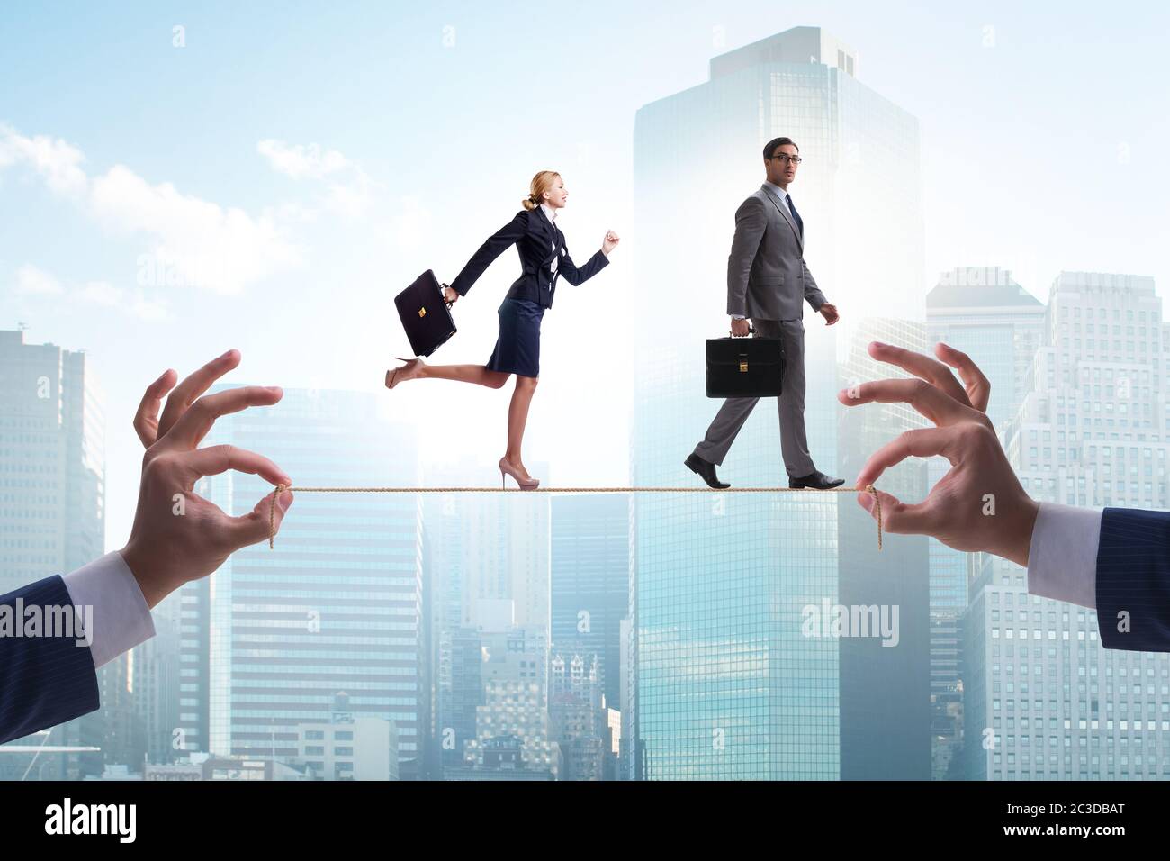 Business people walking on tight rope Stock Photo - Alamy
