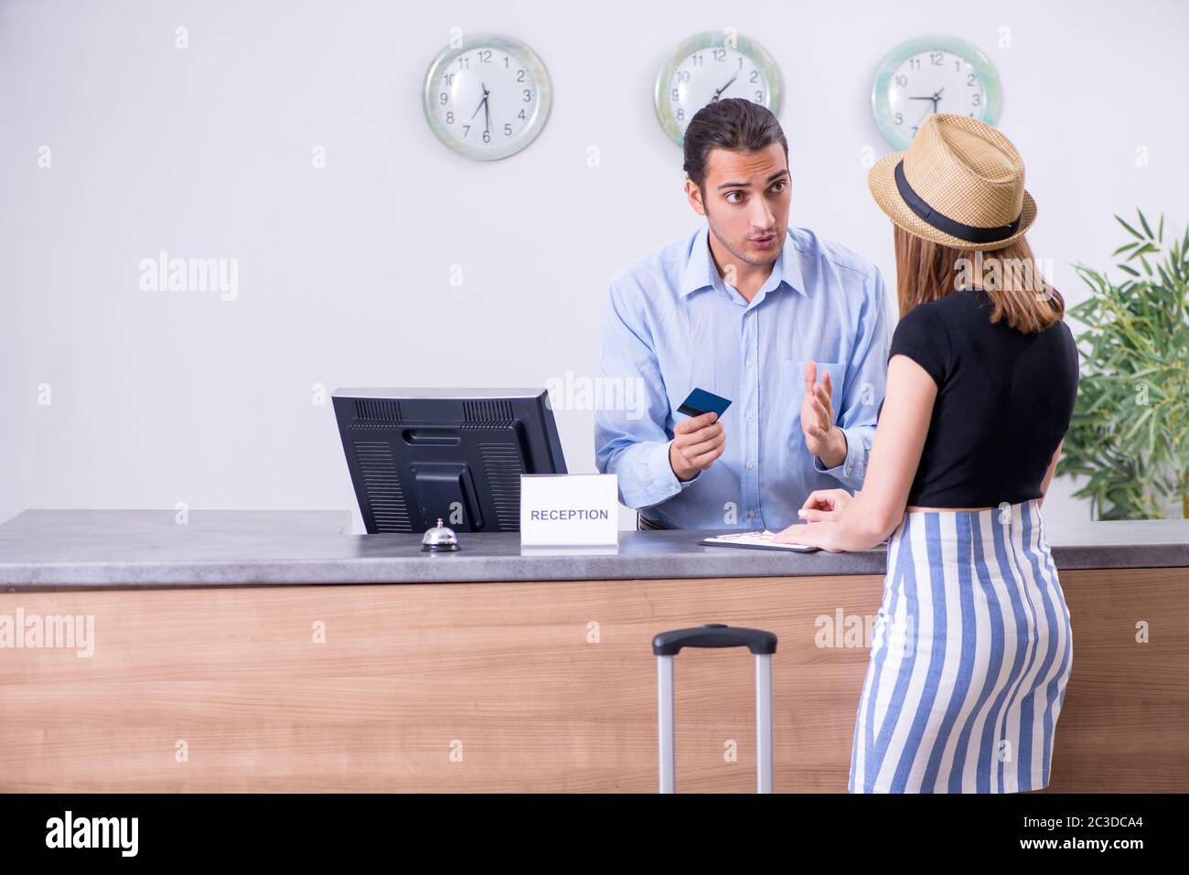 Young woman at hotel reception Stock Photo - Alamy