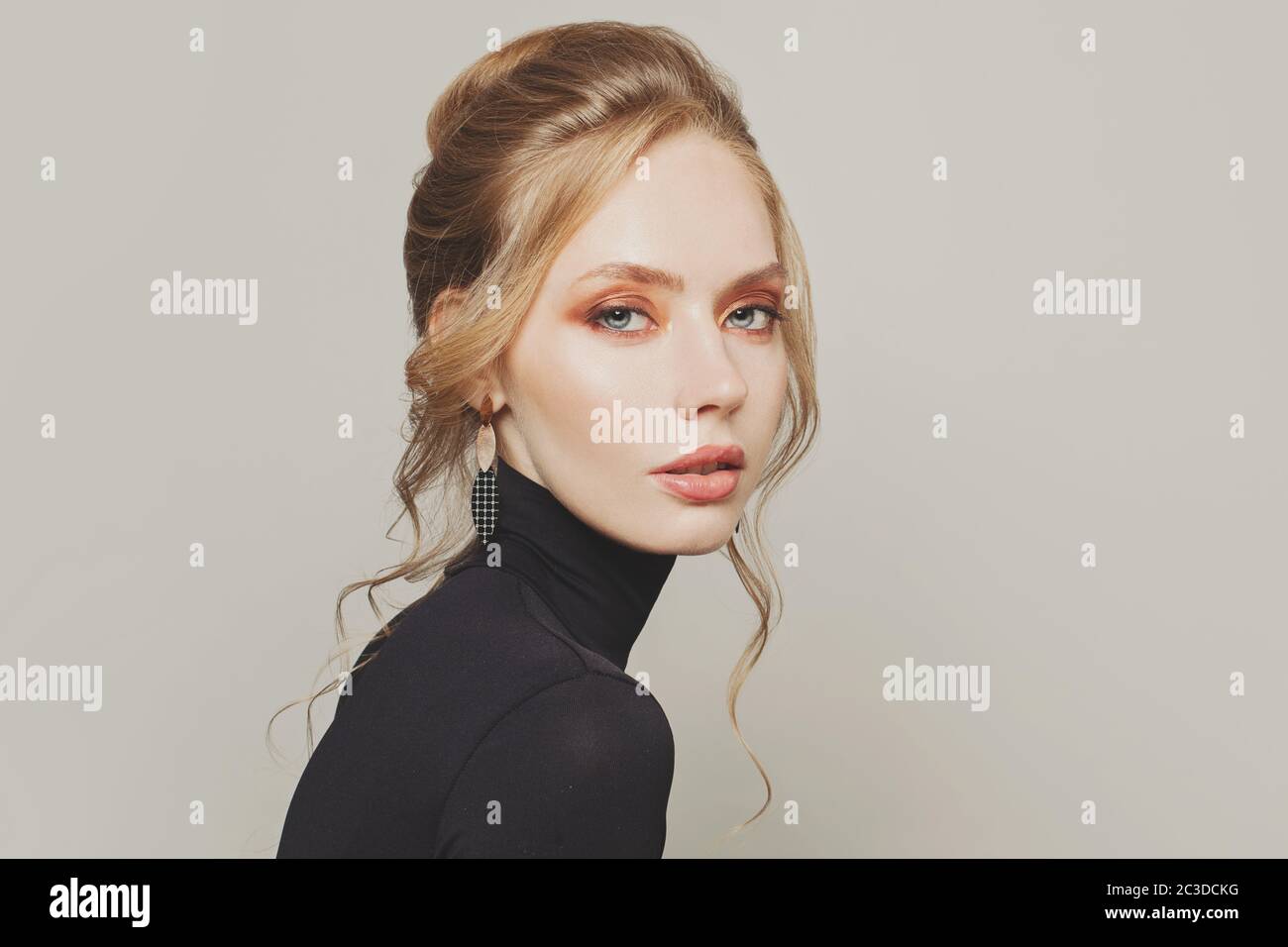 Perfect woman with updo hair wearing black turtleneck sweater portrait ...