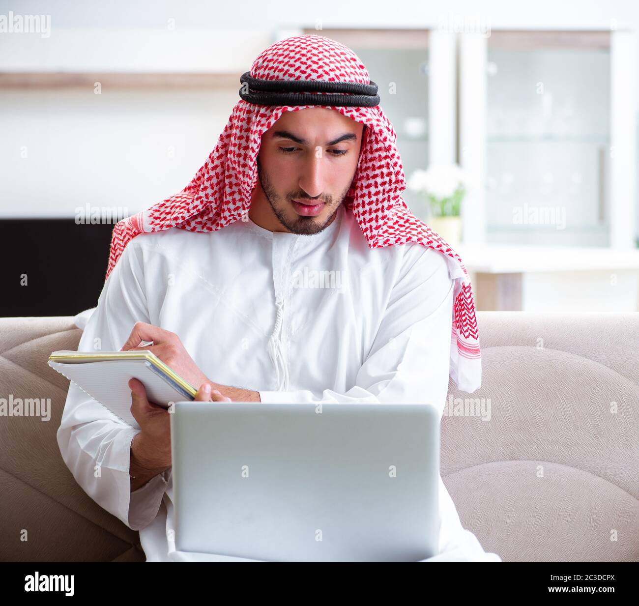Arab man working at home on his work Stock Photo - Alamy