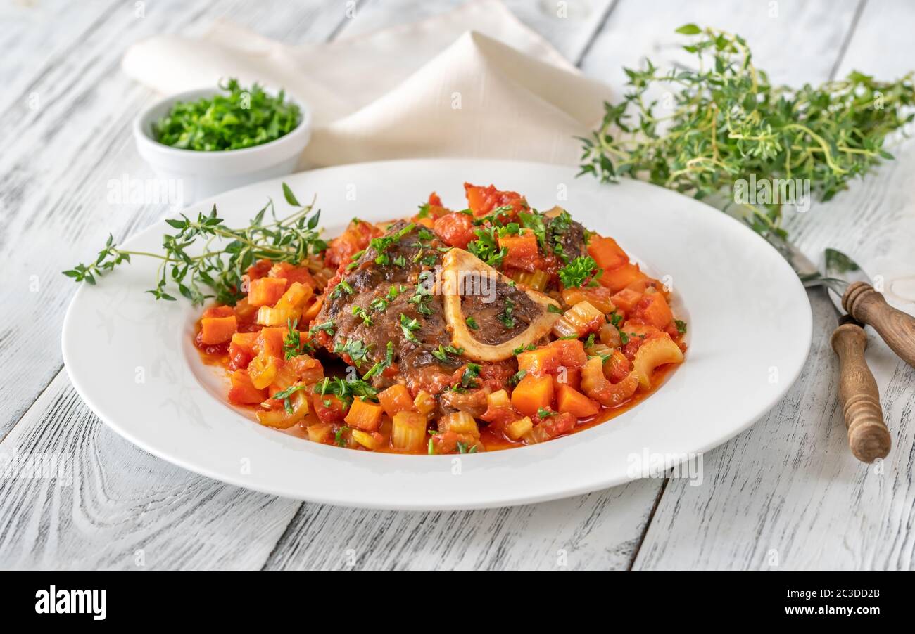 Ossobuco - Italian cuisine specialty with veal shanks and vegetables ...