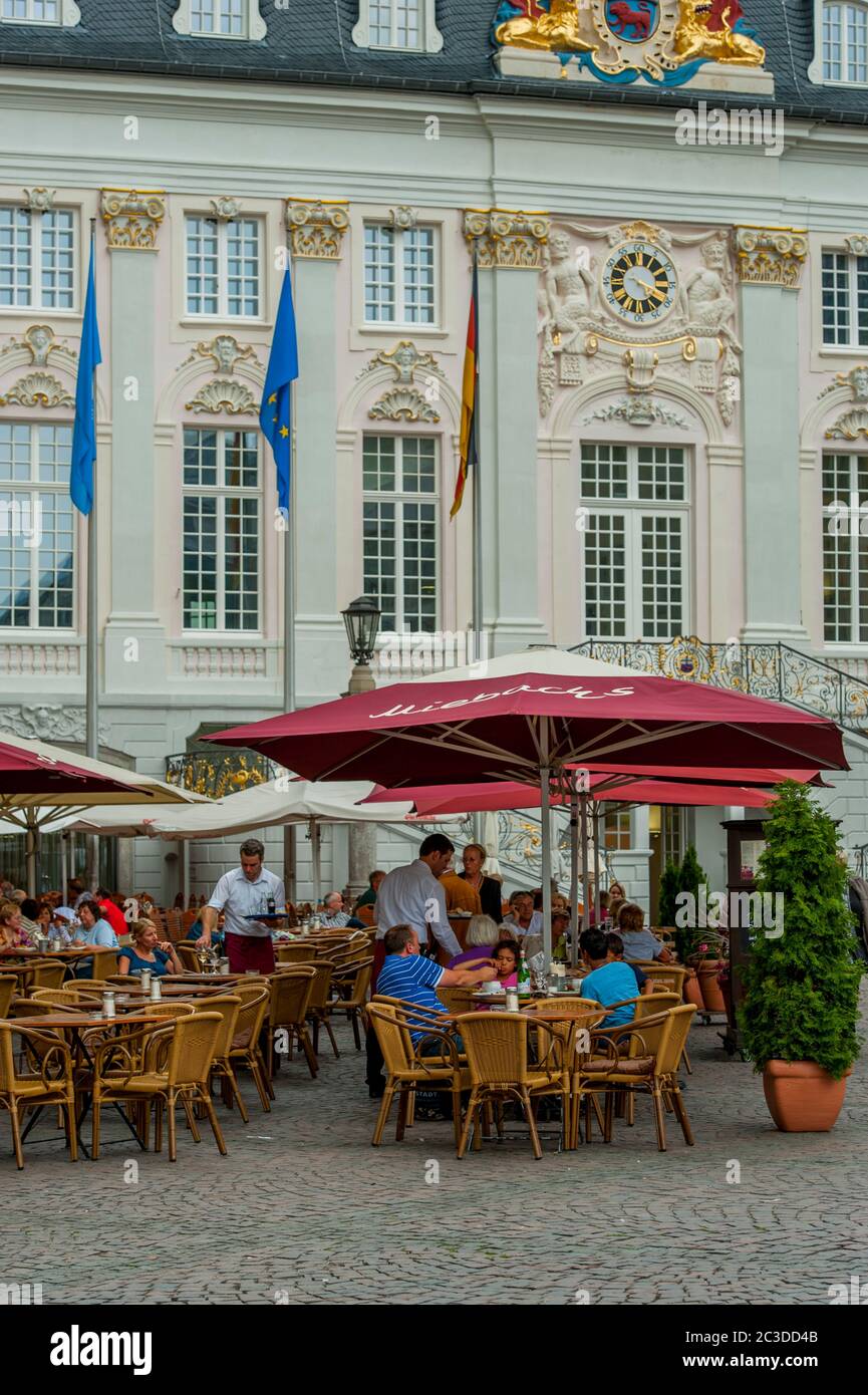 A sidewalk cafe in front of historic town hall (Rococo style) on the ...
