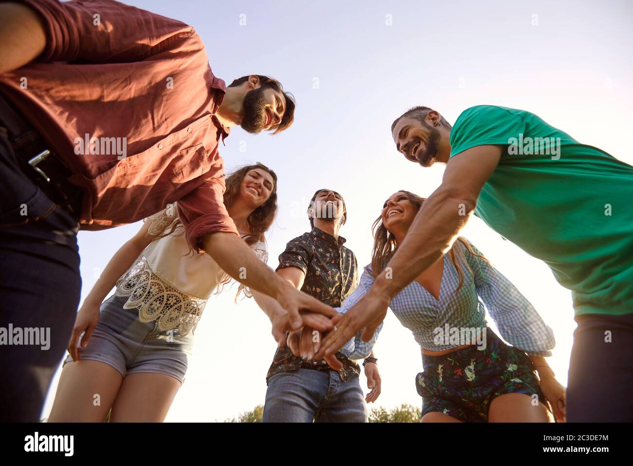 Friends hands together teamwork unity hi-res stock photography and ...