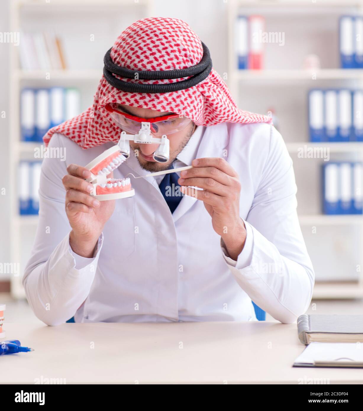 Arab dentist working on new teeth implant Stock Photo - Alamy