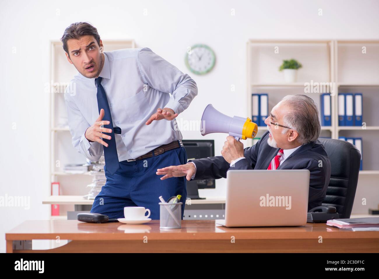 Old boss and young male employee in the office Stock Photo - Alamy