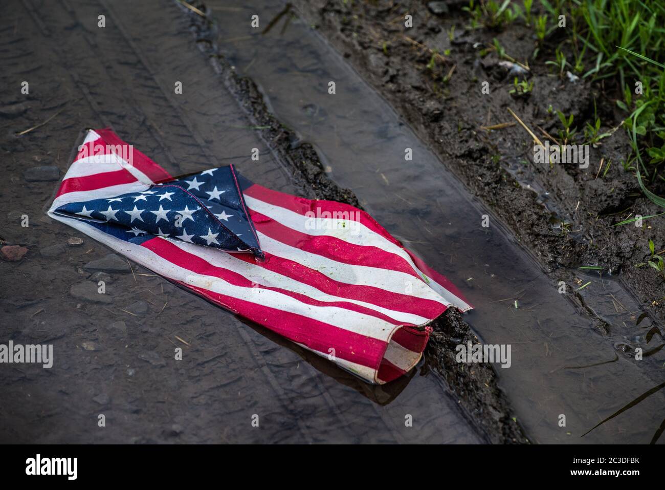 Discarded American flag thrown on ground. desecration Stock Photo - Alamy
