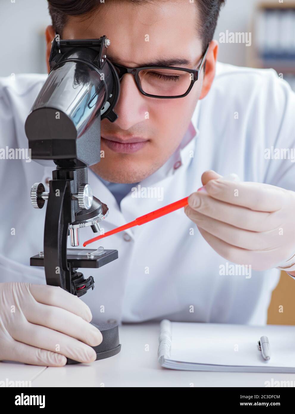 Young doctor doing the blood test Stock Photo - Alamy