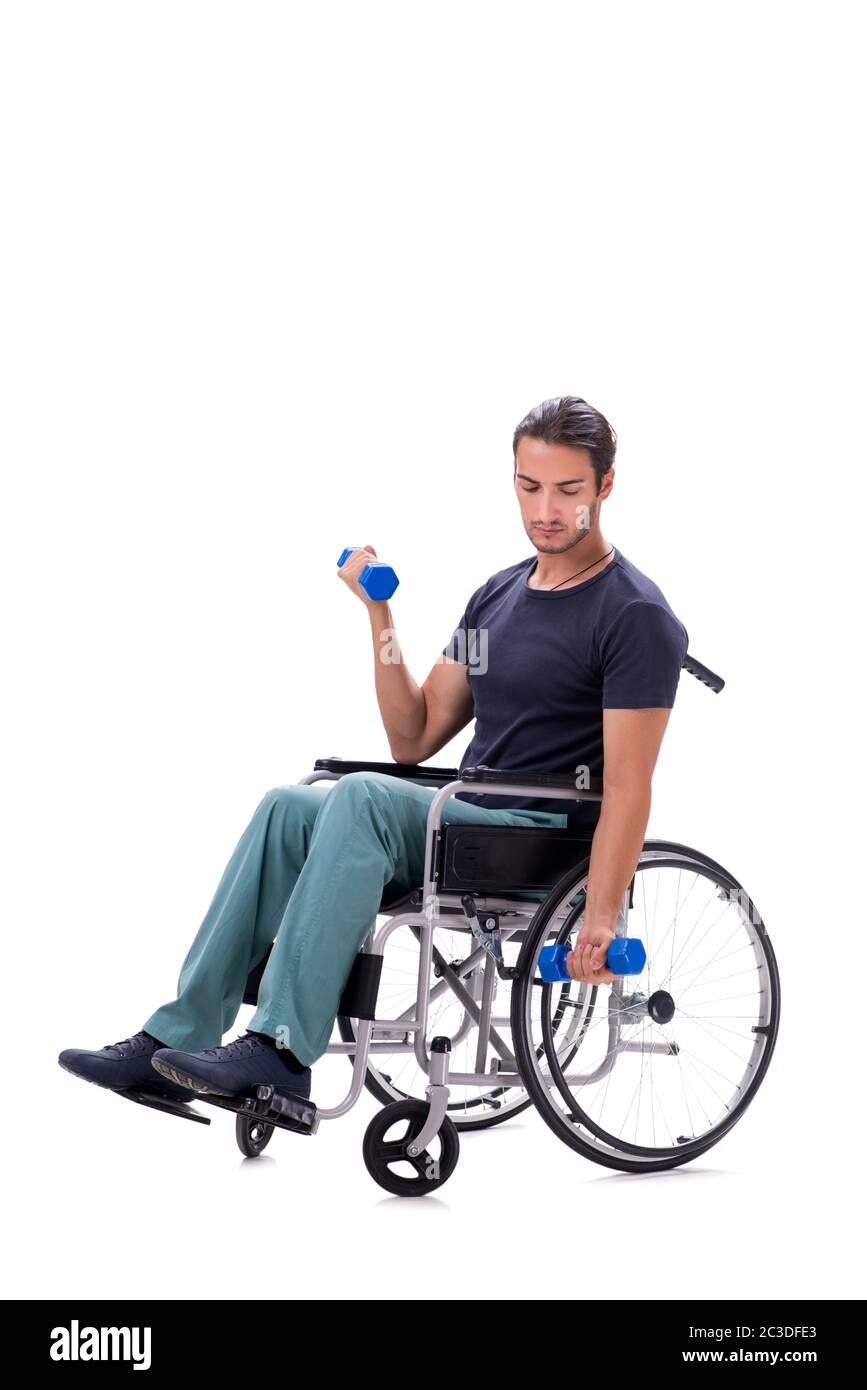 Young disabled man doing physical exercises isolated on white Stock ...