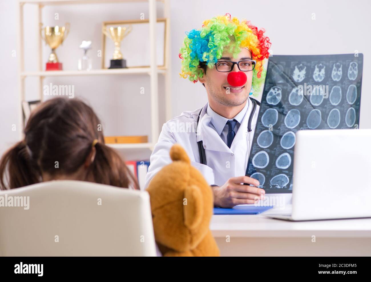 Funny pediatrician with little girl at regular check-up Stock Photo - Alamy