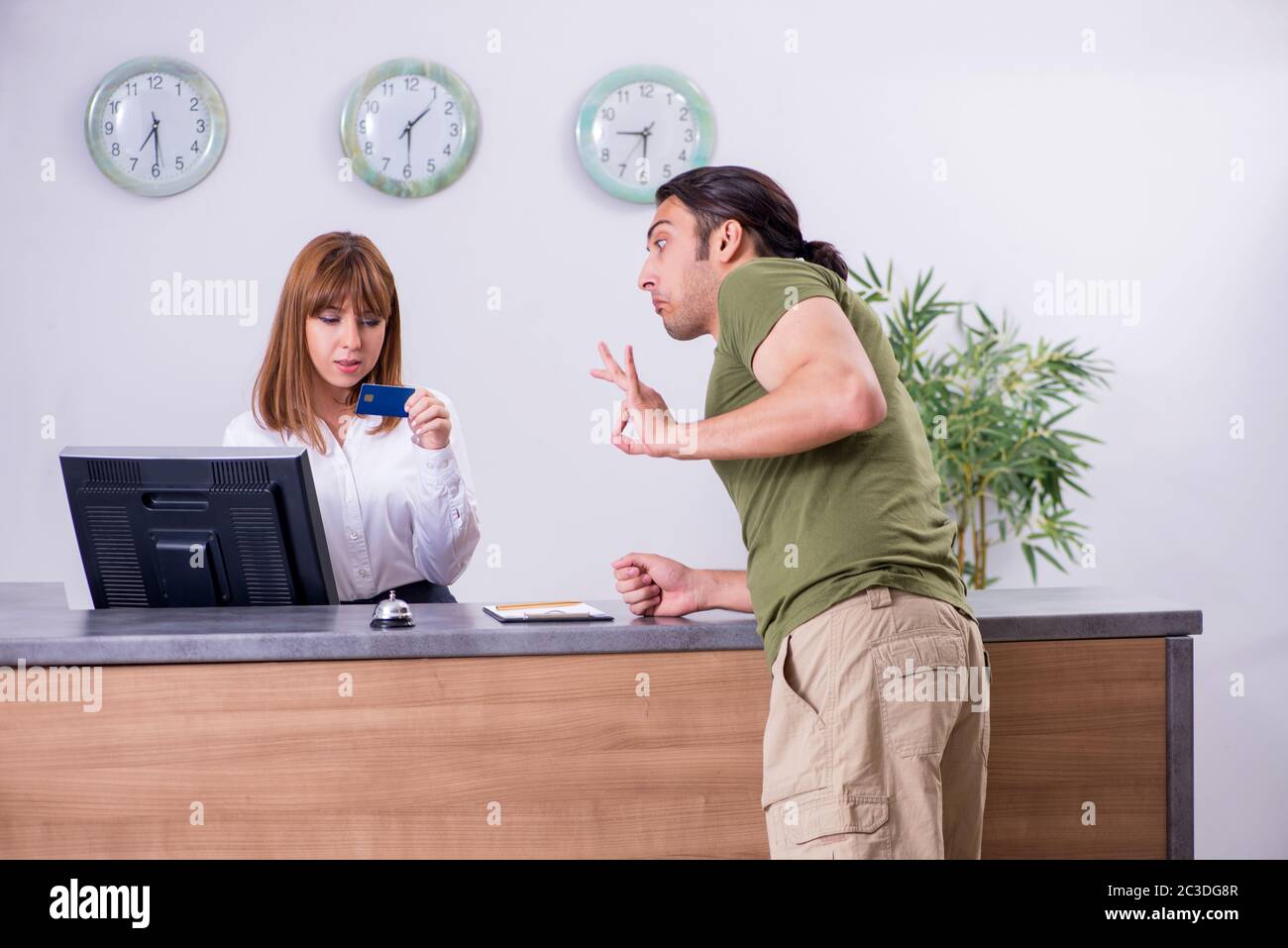 Young man at the hotel reception Stock Photo - Alamy
