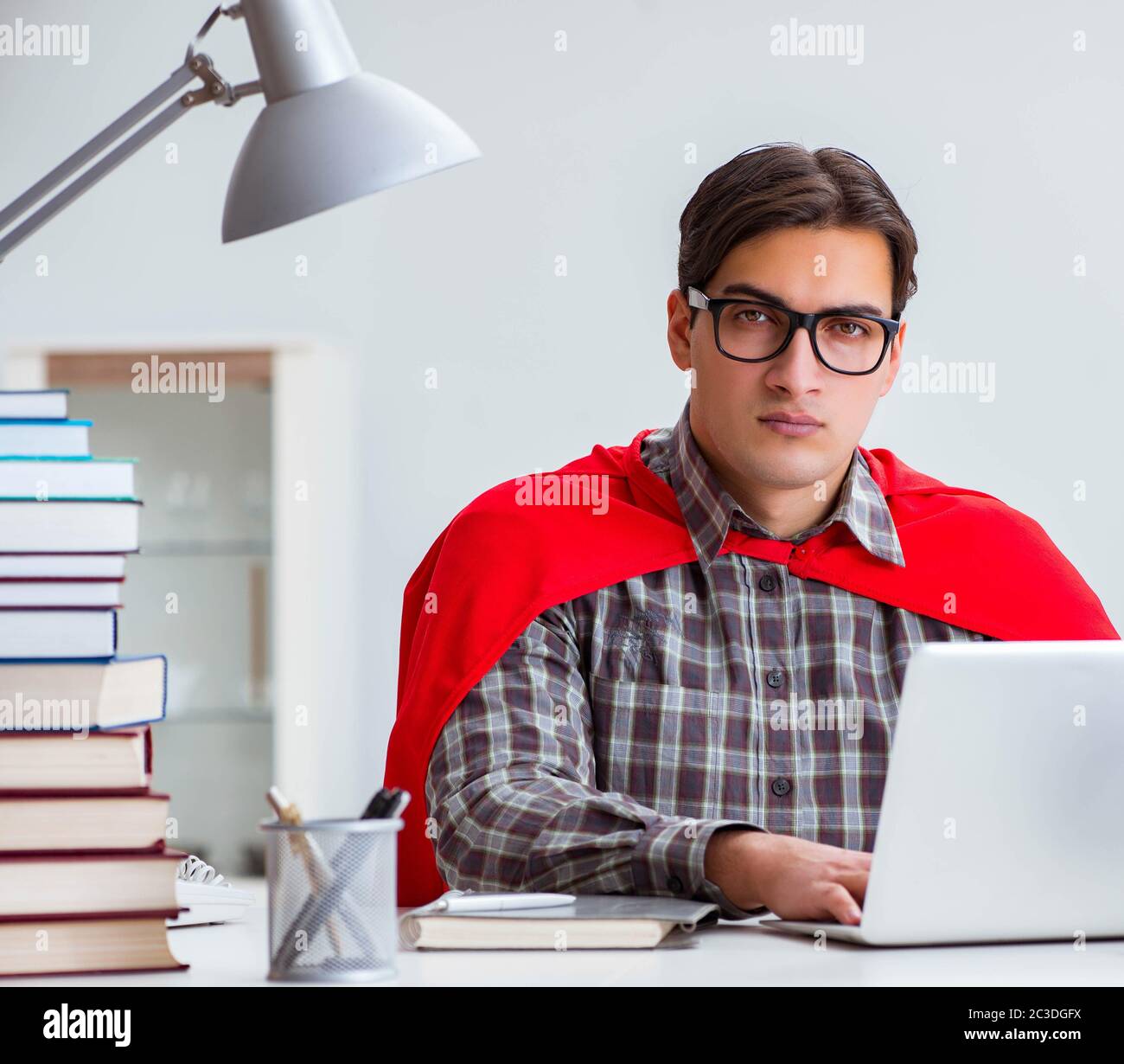 Super hero student with books studying for exams Stock Photo - Alamy