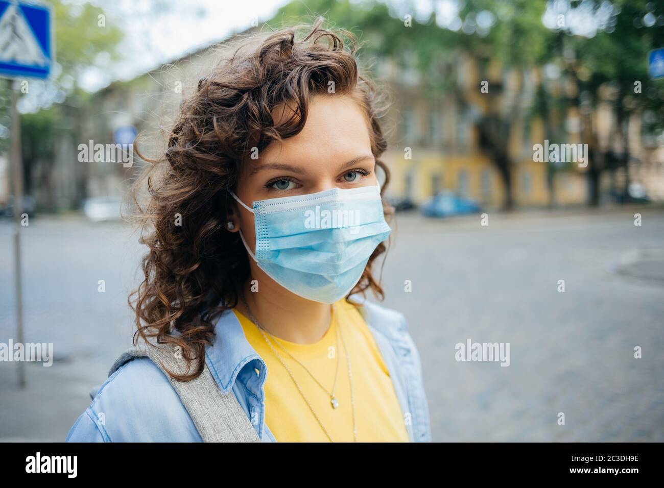 Portrait young woman wearing medical mask for protection against the ...