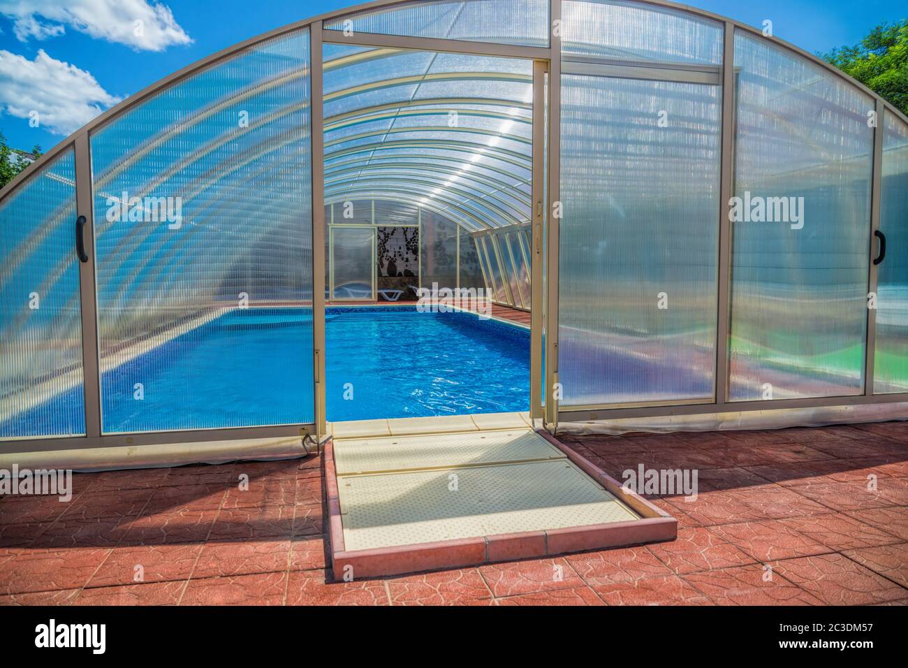 Covered summer pool with a blue tile. The covered area of the outdoor ...