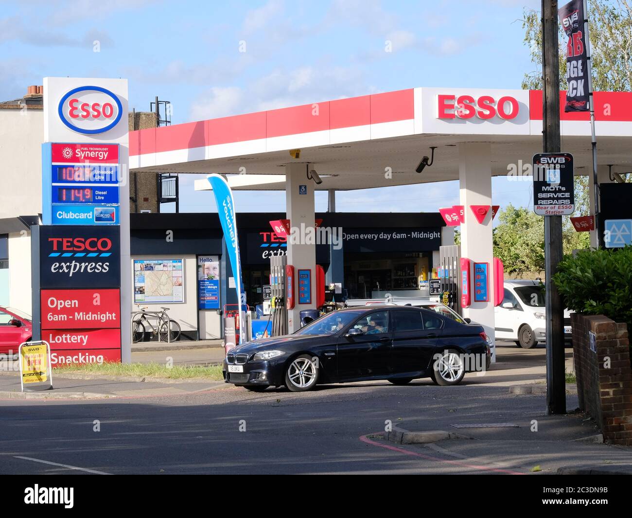Esso service station with car driving driving out from the forecourt Stock Photo - Alamy