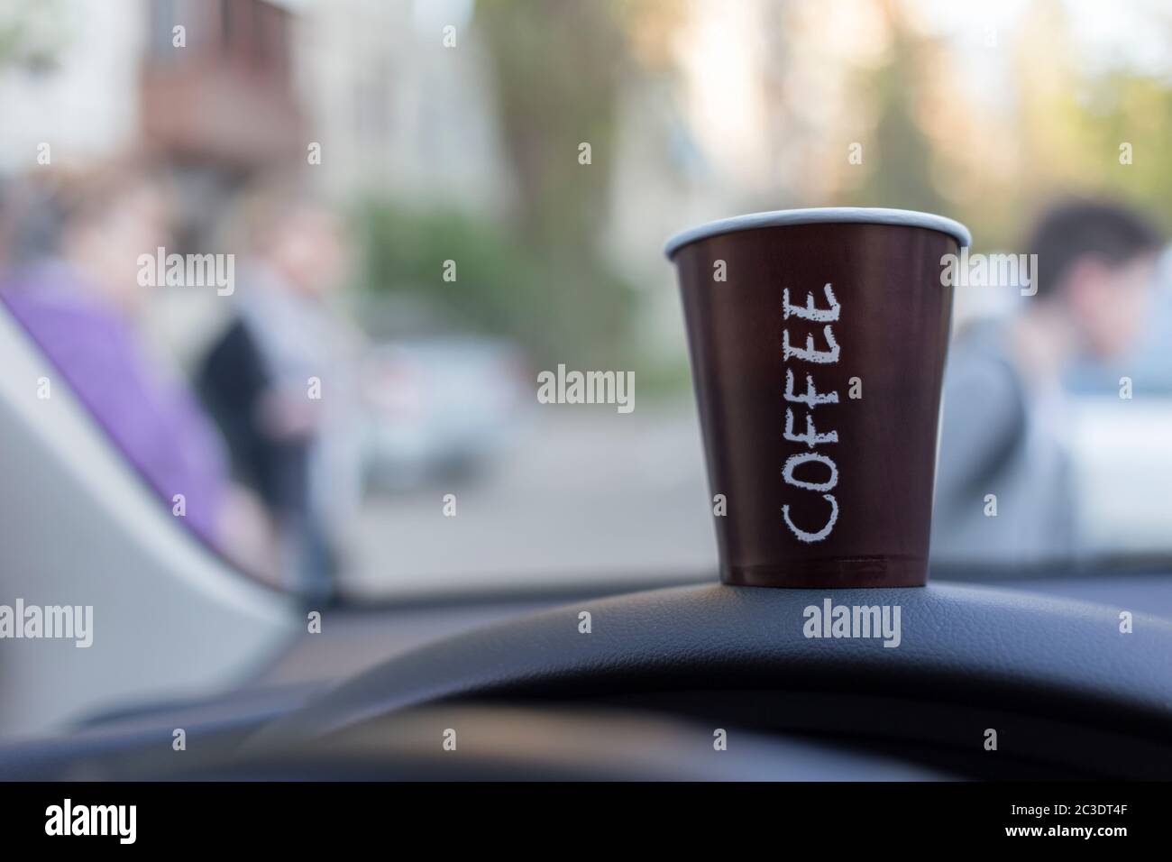 Cup of hot coffee on car console. Blurred background Stock Photo - Alamy