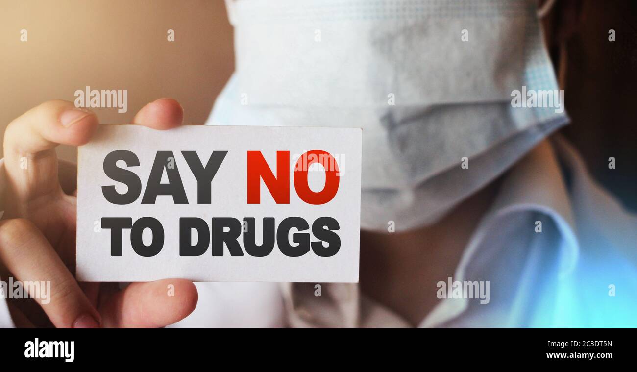 Doctor holding a card with Say no to drugs, Medical drugs addiction ...