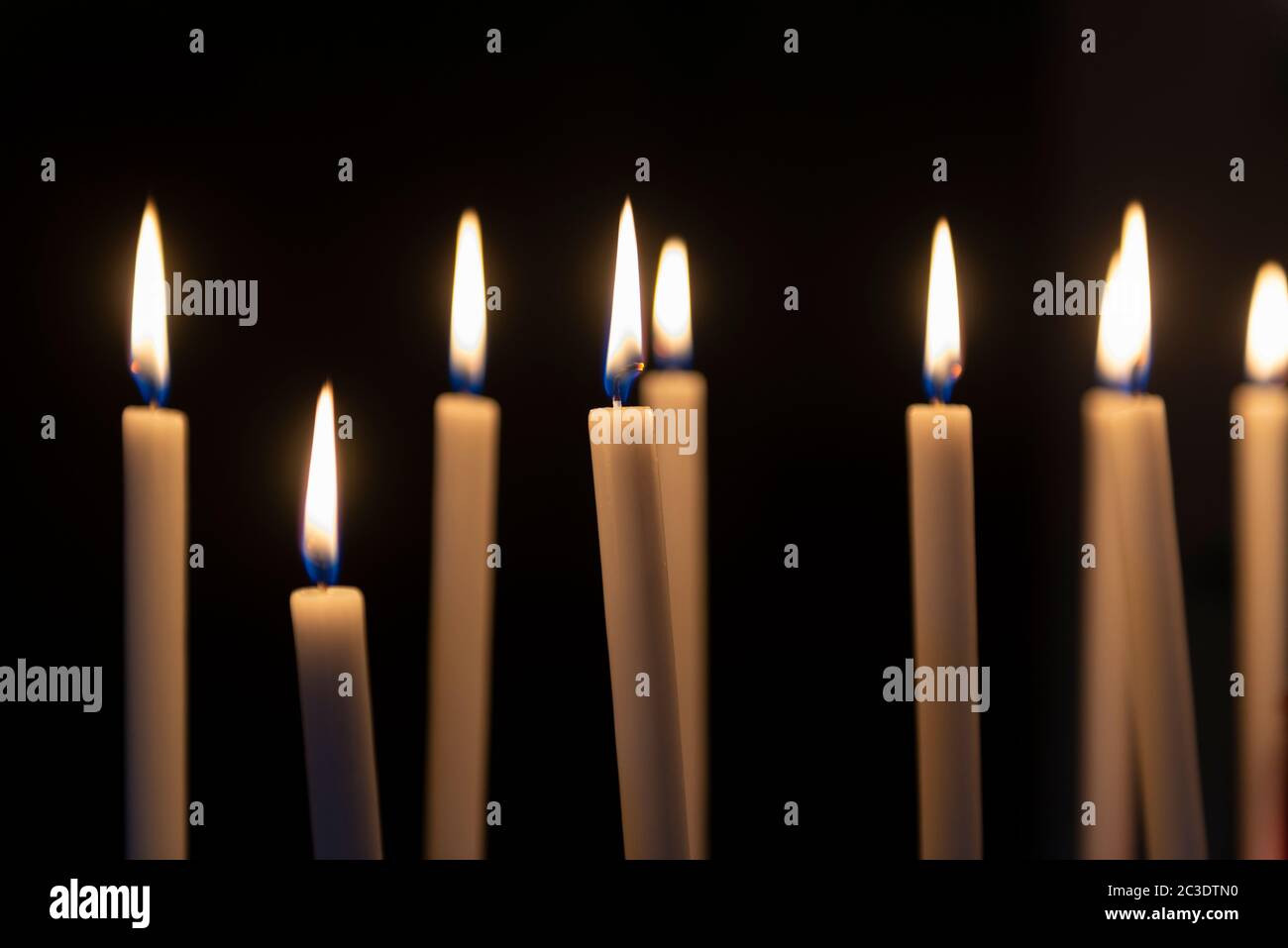 Burning candles on dark background. Symbol of memory Stock Photo - Alamy