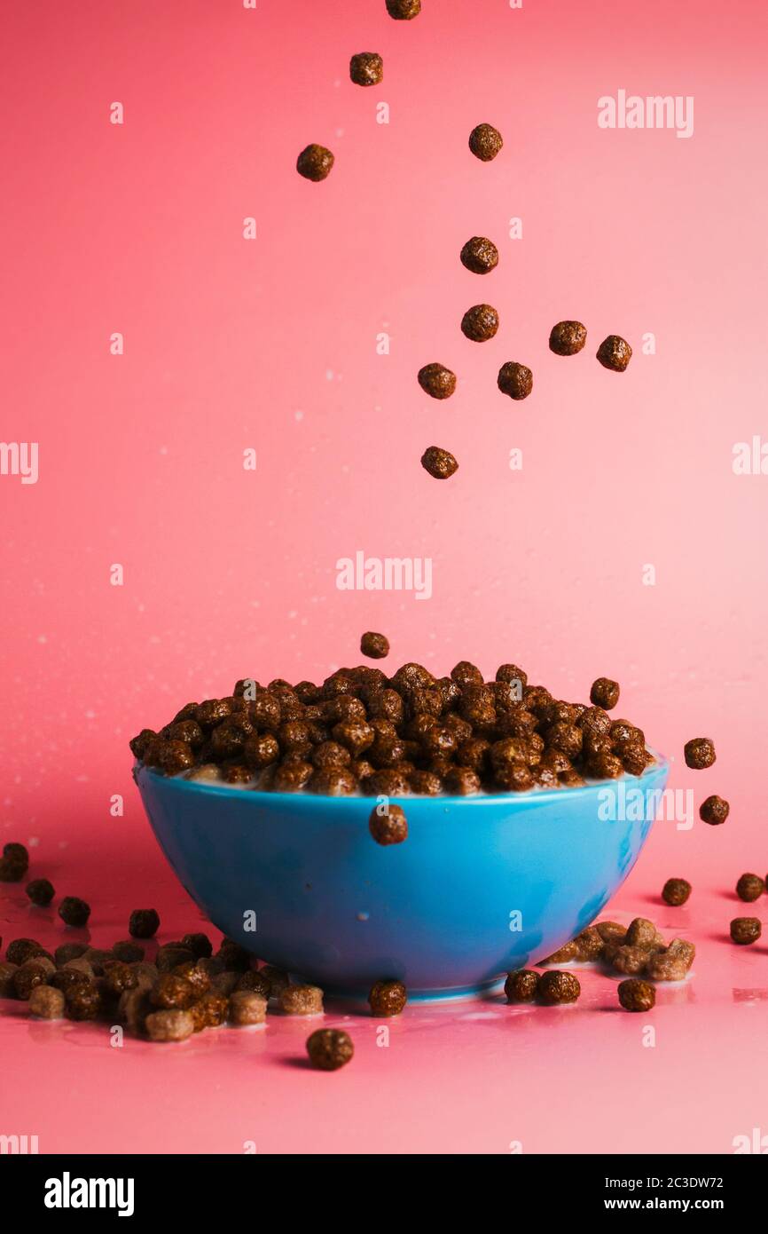 Chocolate breakfast cereals falling into the bowl, concept of breakfast ...