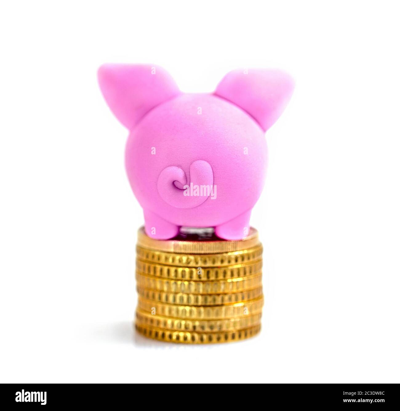 Pink piggy bank and coins Stock Photo - Alamy