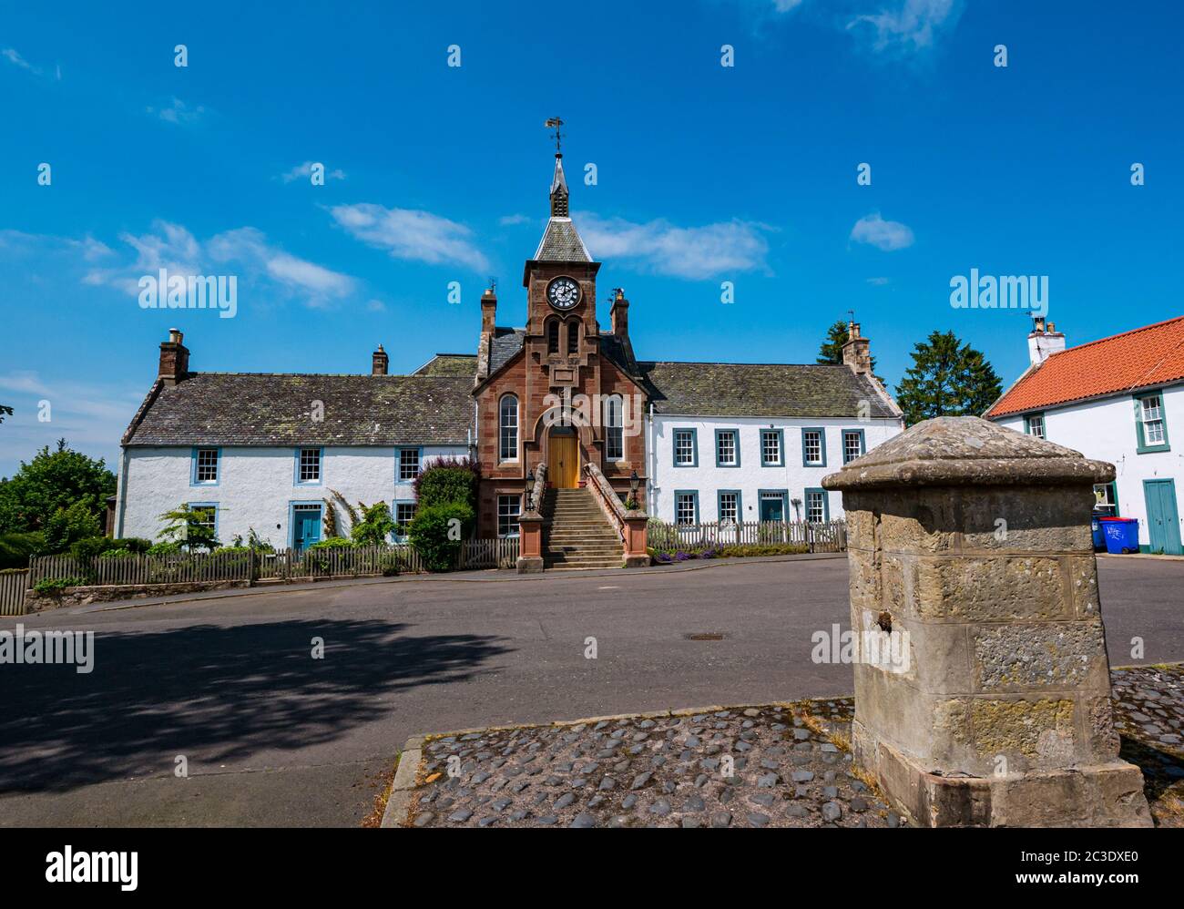 Gifford village hall, with clock tower on sunny day with blue sky, East ...