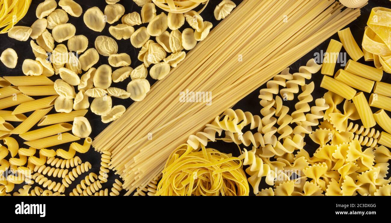 Italian pasta variety panorama, a flat lay of many different pasta ...