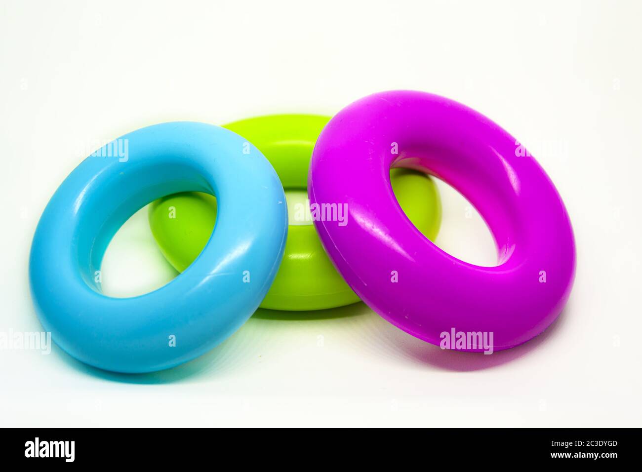 three colored plastic rings isolated on a white background. Children's ...