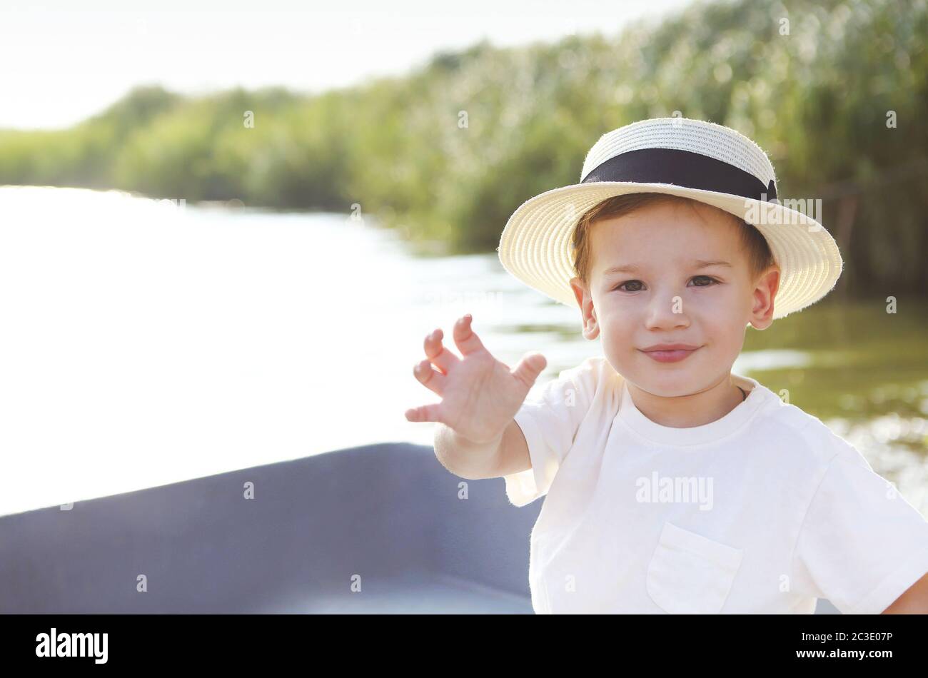 Happy kid sitting wearing hat in the boat Stock Photo - Alamy