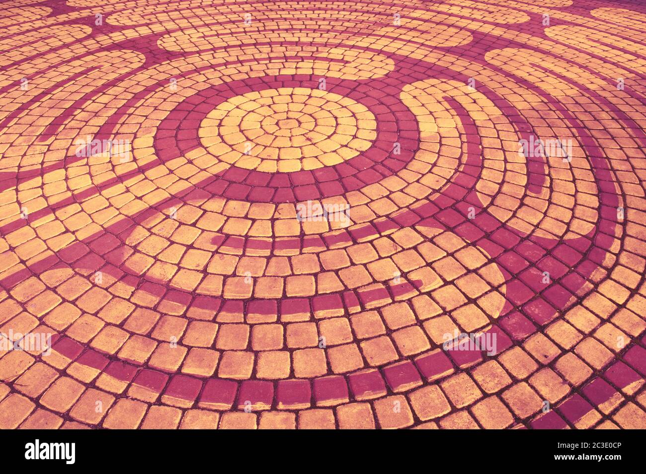 Colorful labyrinth on the pavement. Colored paving granite cubes create ...