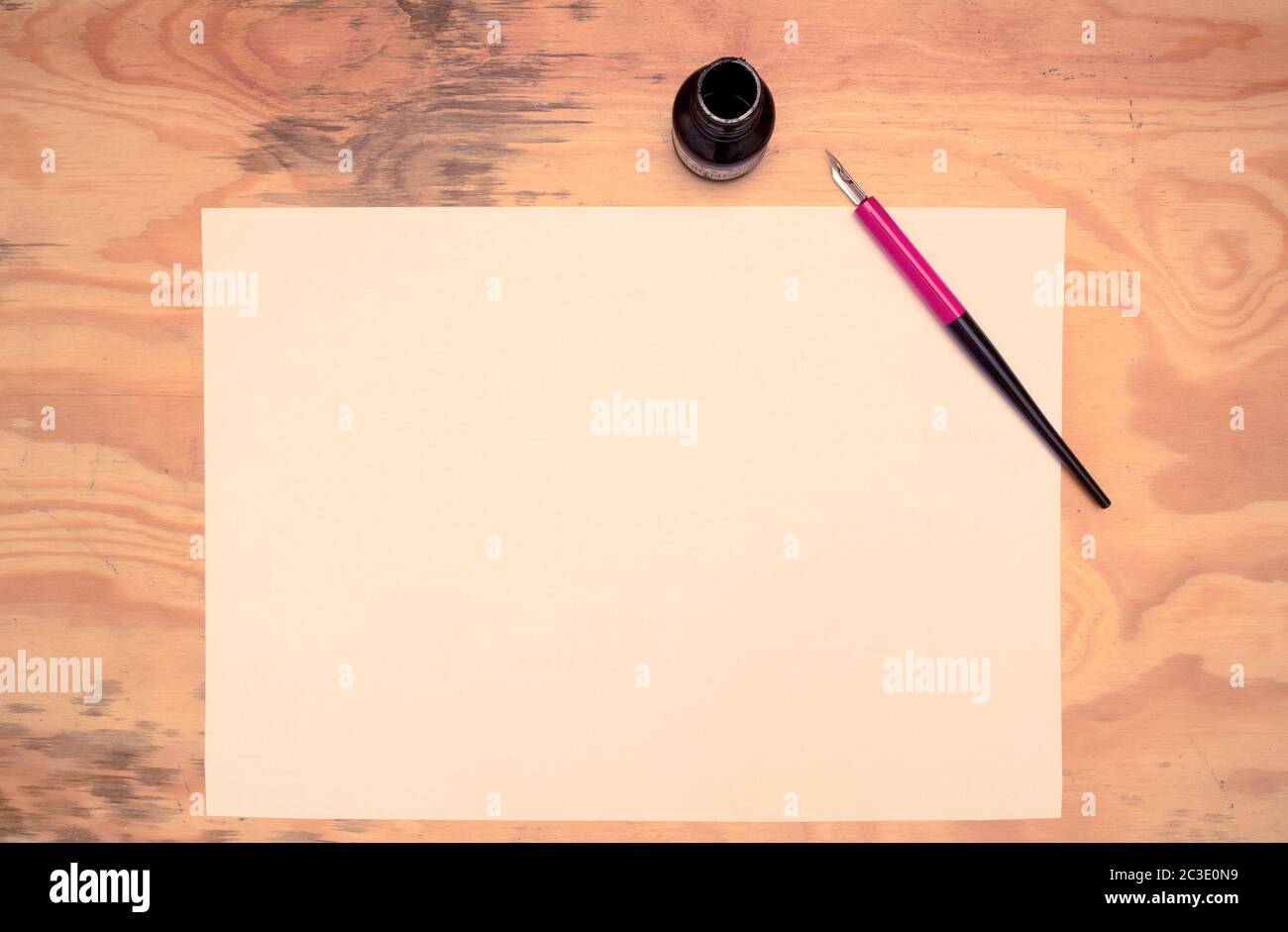 Flat lay - ink bottle, pen, paper, wooden desk (vintage color shift ...