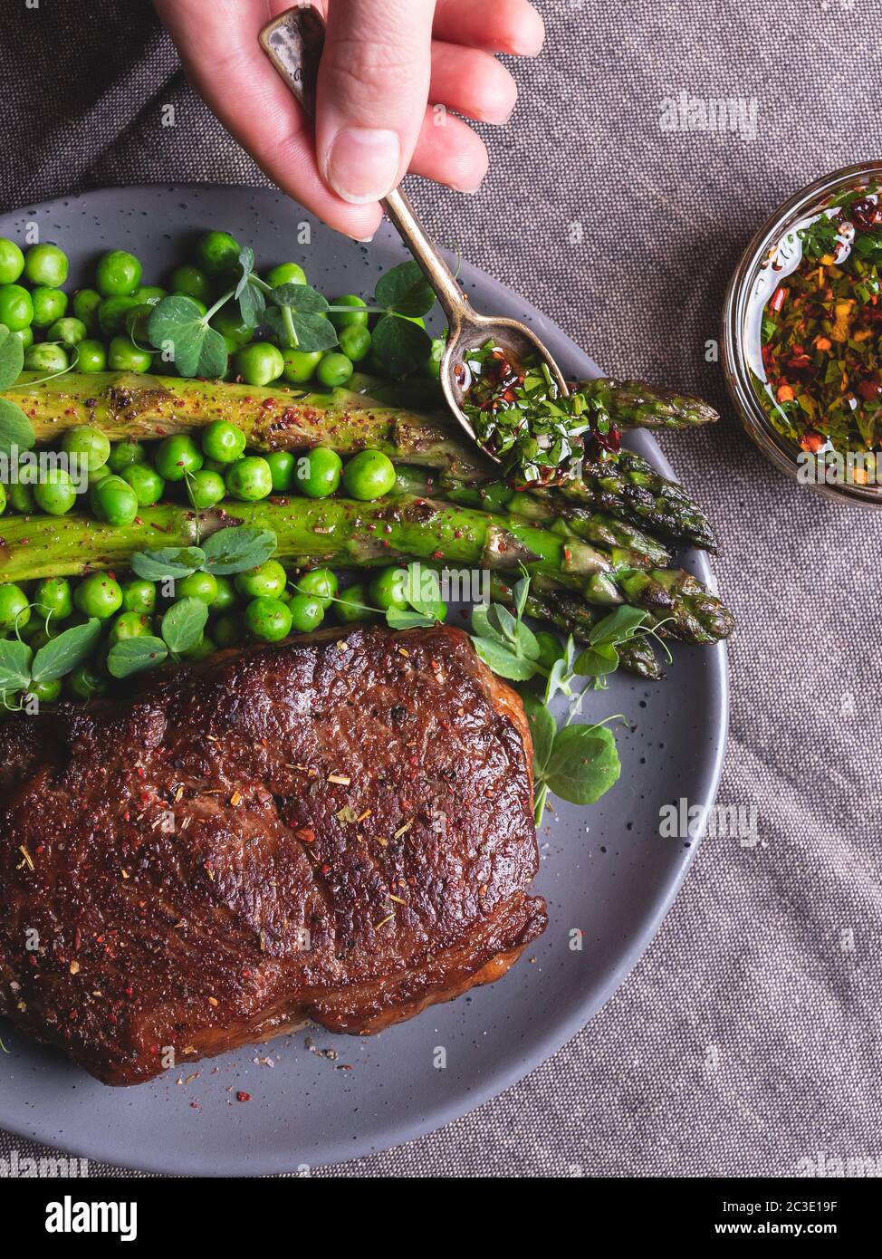 Hand adds sauce steak hi-res stock photography and images - Alamy
