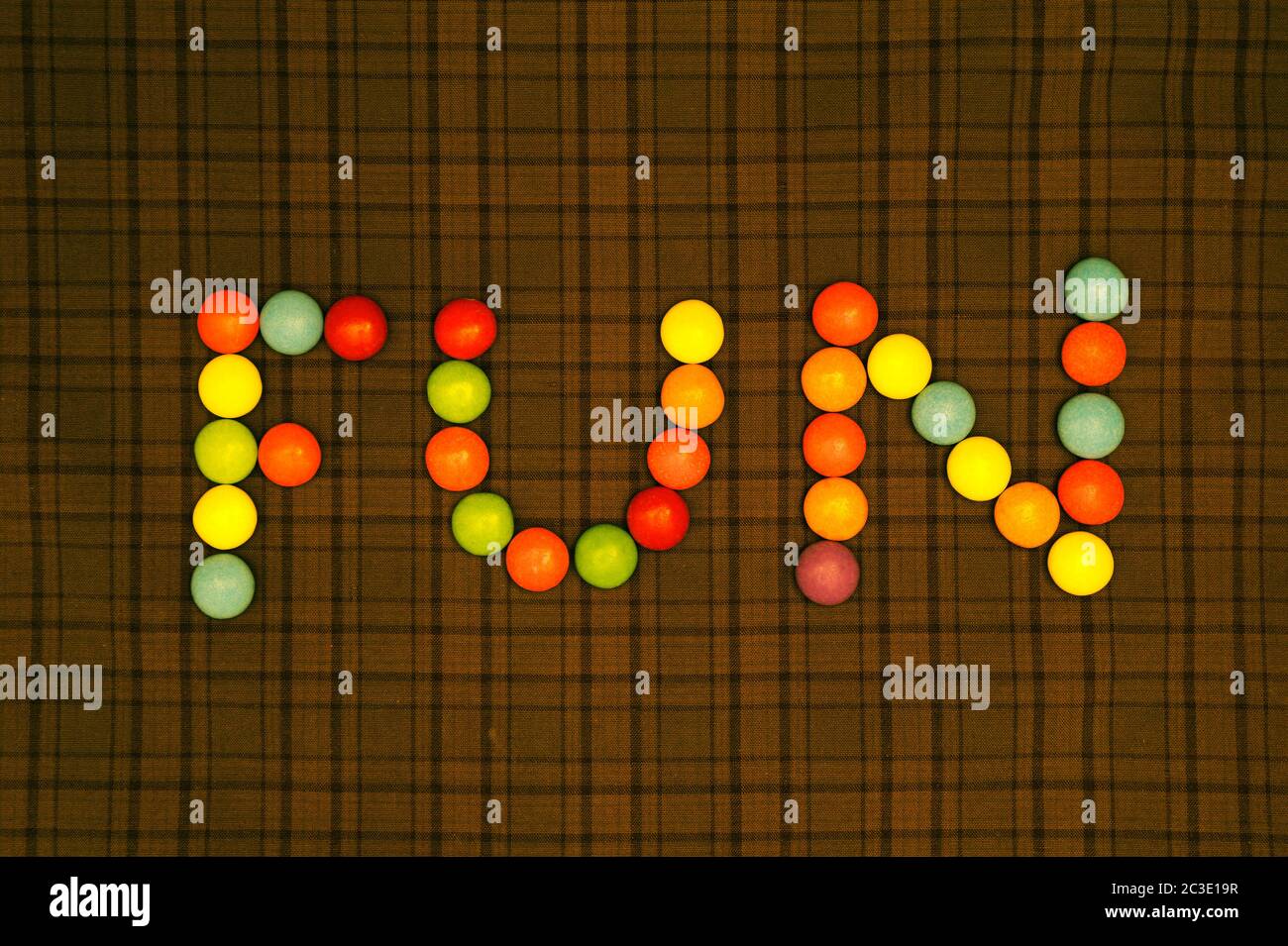 Fun - text made by composition of color dots on checked fabric ...