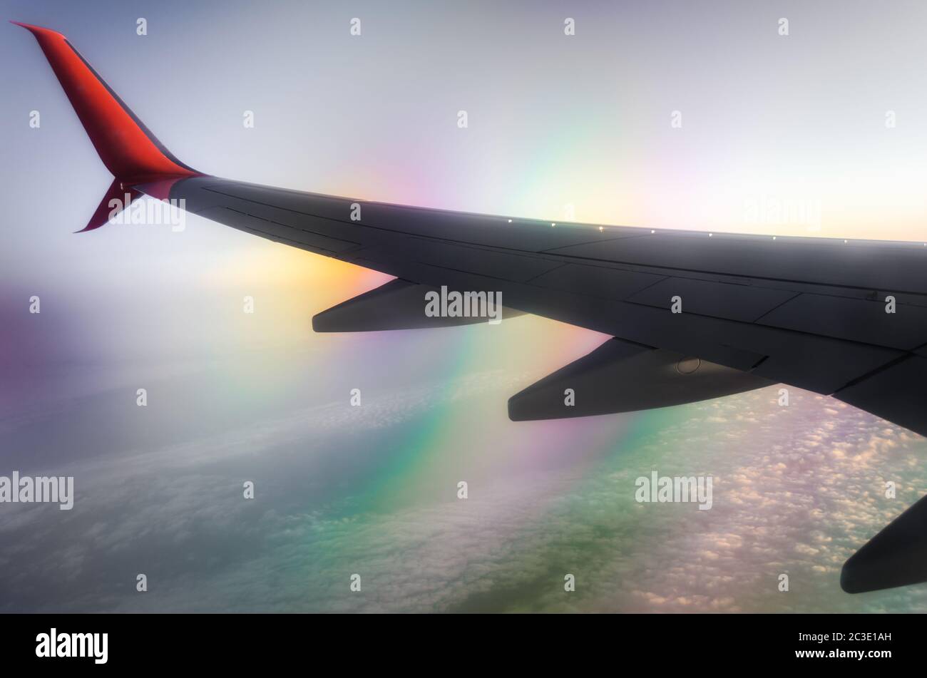 airplane wing in flight above clouds with optical effect Stock Photo ...
