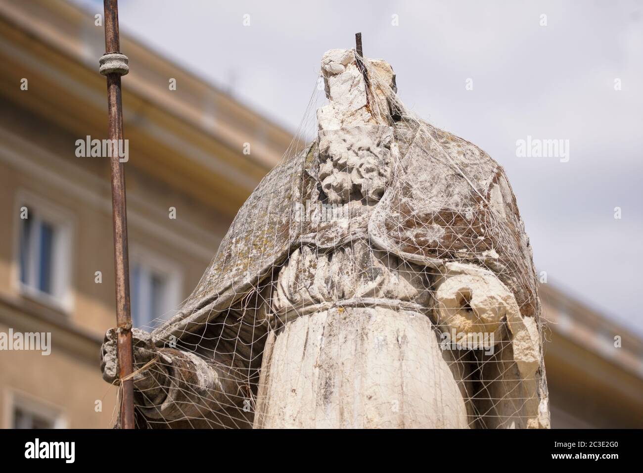 A damaged sculpture missing part of it's head is seen in front of the ...