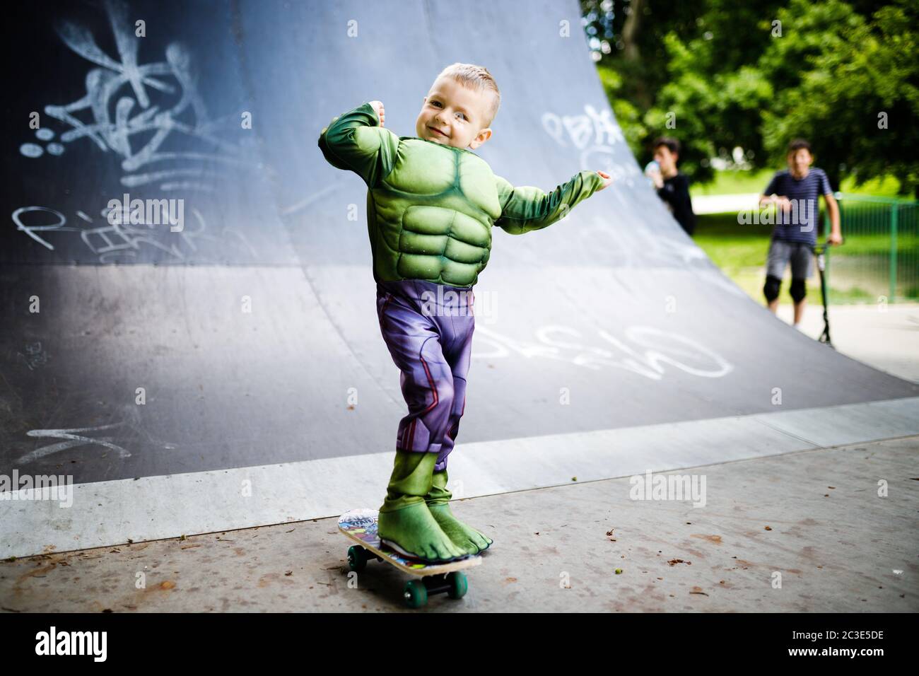 Boy with a skate in a skate park. In a superhero costume Stock Photo ...