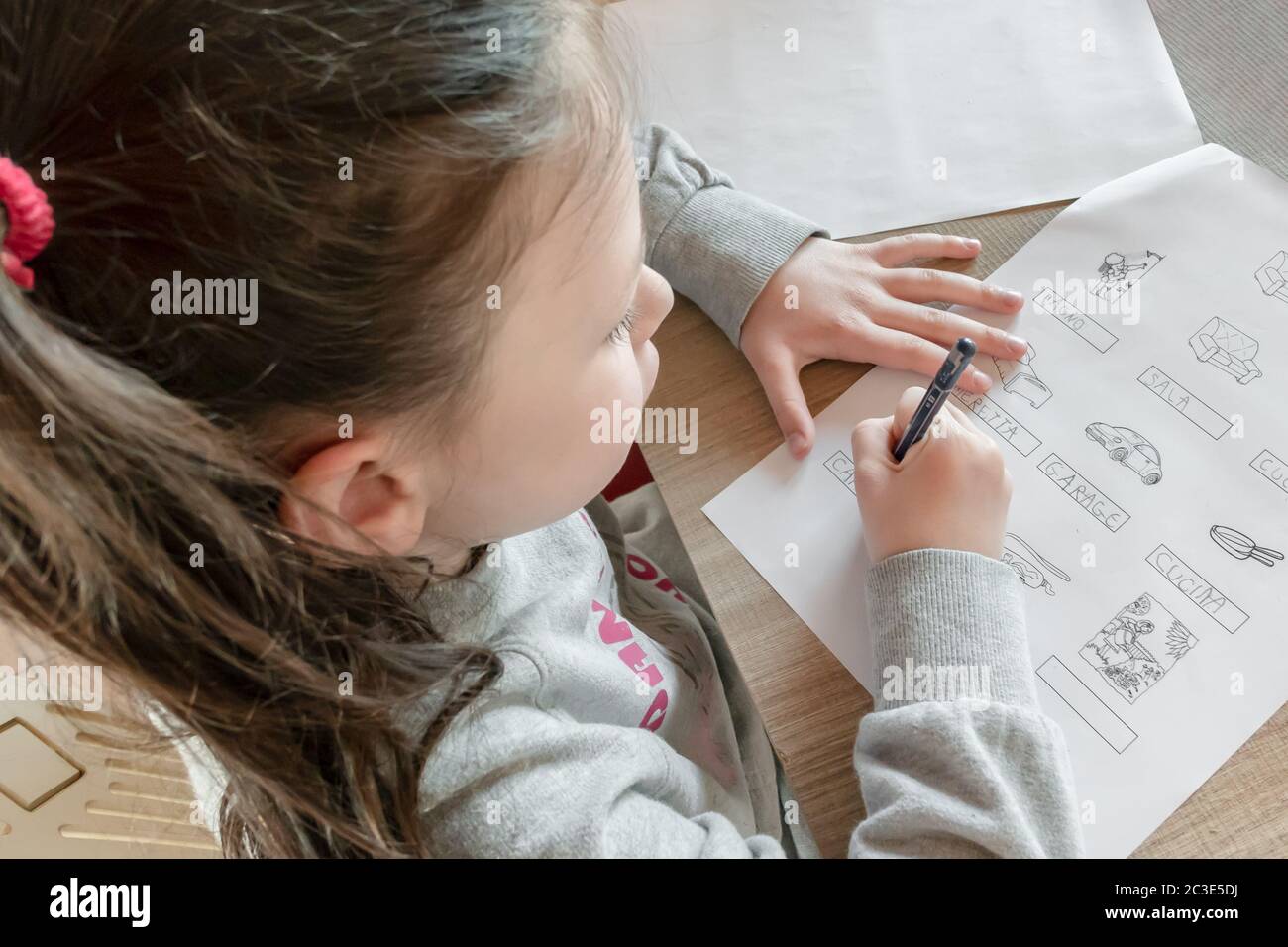 Baby girl learning to write Stock Photo - Alamy