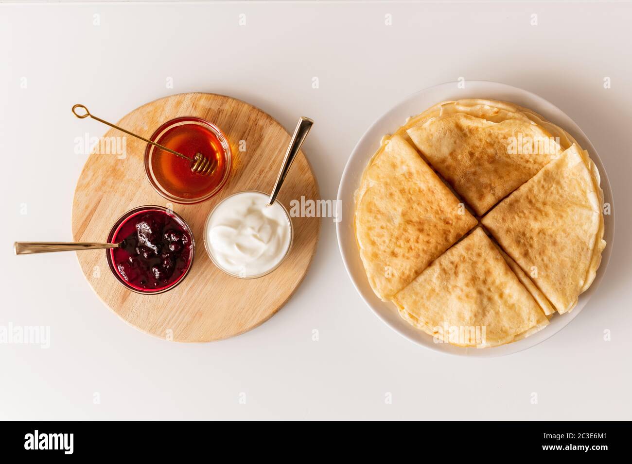 Overview of fresh homemade folded pancakes on plate and small glass ...