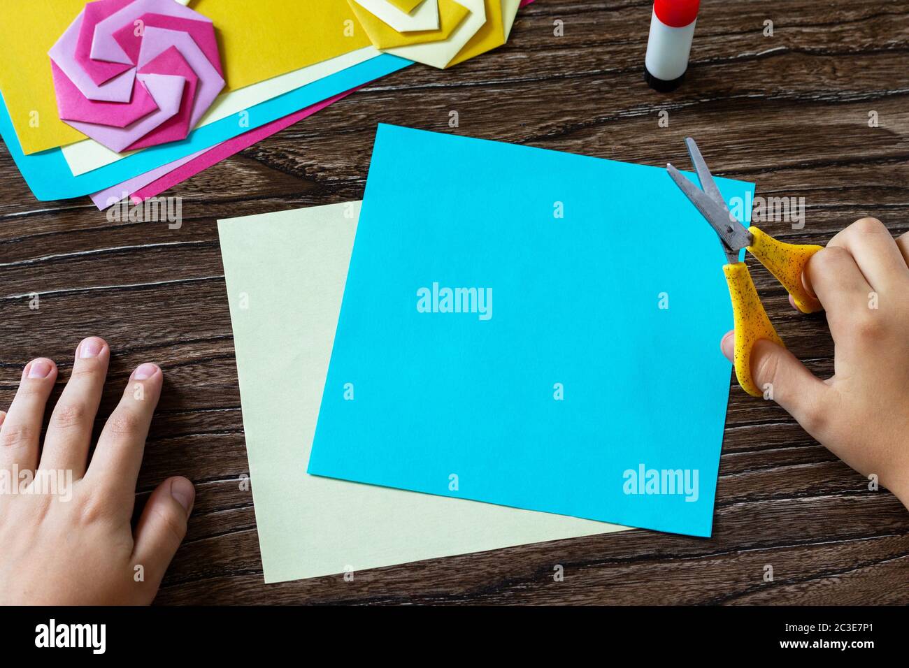 Instruction step 2. Funny toy Origami paper ice cream on a wooden table ...