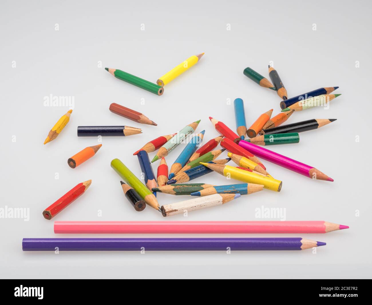 Colored pencils. Short and long sharpened pencils. White background. Stationery for drawing ...
